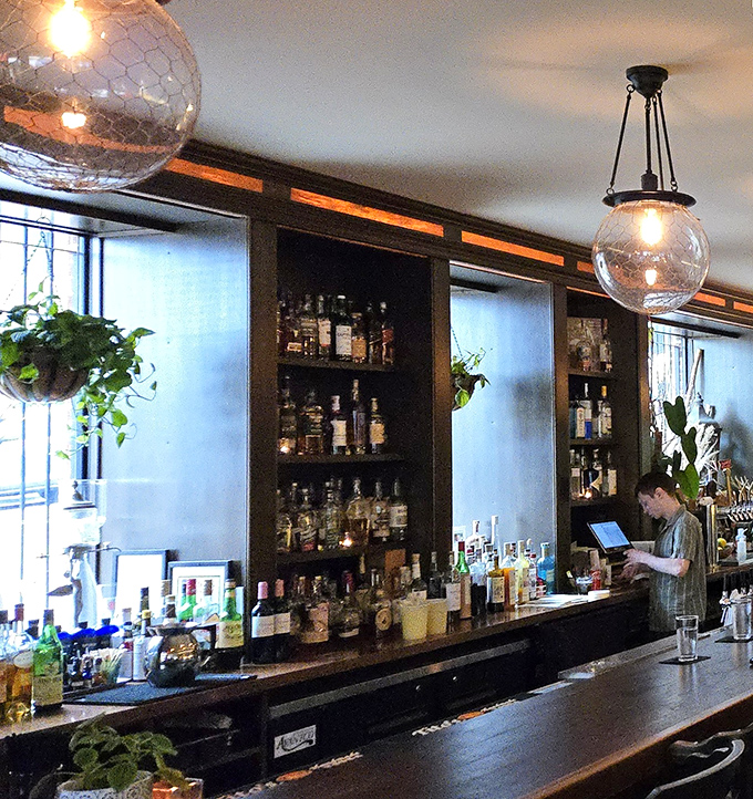 A bar stocked like a liquid library, where botanical-infused spirits and housemade ingredients await their perfect match.