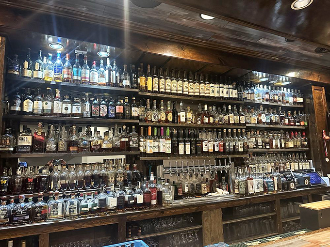 A whiskey collection that would make bourbon country blush, displayed like liquid amber trophies behind the bar.