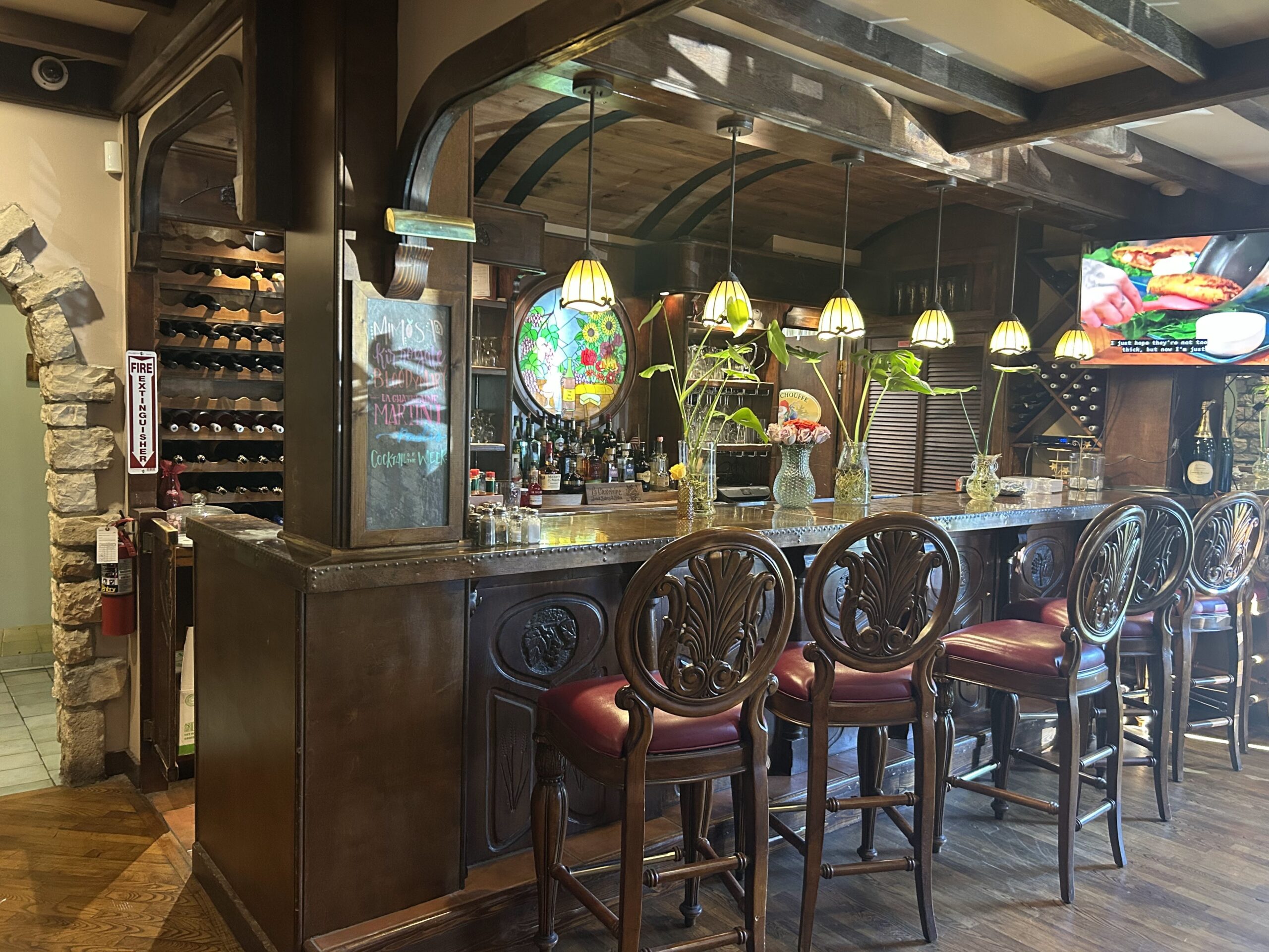 The bar area combines Old World elegance with Midwestern hospitality&mdash;those carved wooden chairs aren't just seating, they're thrones for everyday royalty.