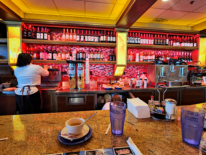 The bar area glows with ruby-red backlighting&mdash;where coffee by day transforms to cocktails by night without missing a beat.