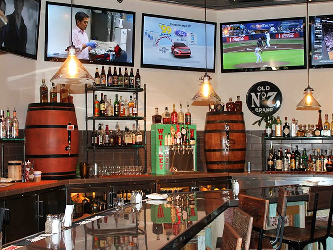 Barrel accents and pendant lighting give the bar area a whiskey-forward vibe that perfectly complements the smoky flavors coming from the kitchen.