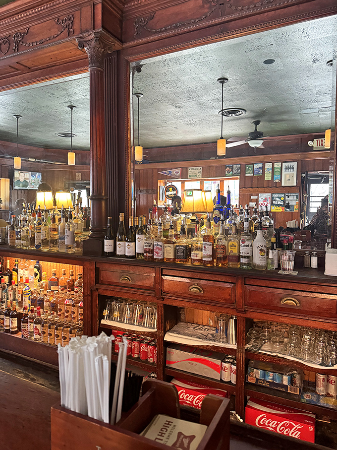 The warm glow of pendant lights illuminates bottles like treasures in a museum of liquid happiness, each waiting to become part of your evening's story.