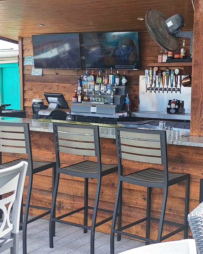 The outdoor bar combines rustic wood with modern convenience&mdash;exactly where you want to be when Florida decides to behave weather-wise.