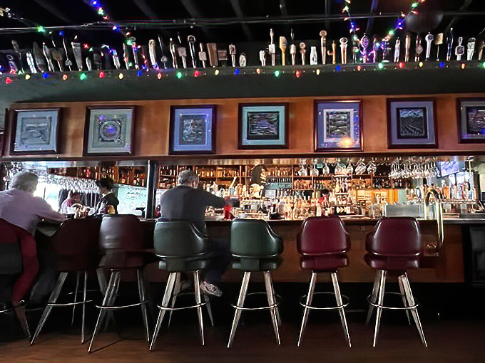 Bar stools lined up like eager patrons waiting for their turn. The impressive bottle collection suggests adventures that begin with "Just one drink..."