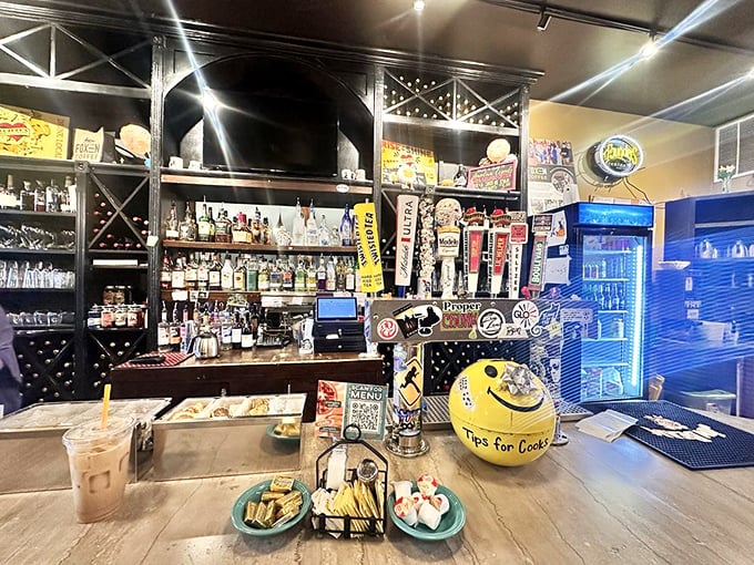 Behind that bar, bottles and taps stand ready to transform your breakfast into brunch with proper liquid reinforcements and a smile.