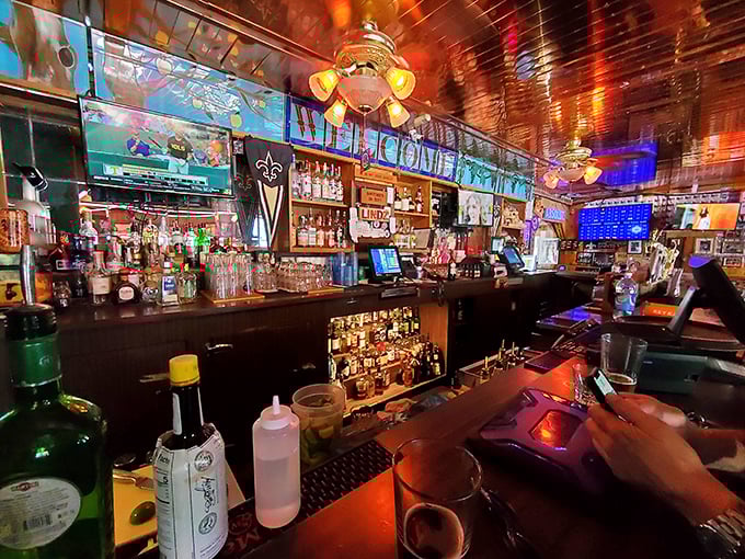 Behind the bar, where liquid happiness flows freely and the warm glow of neon signs promises good times ahead.