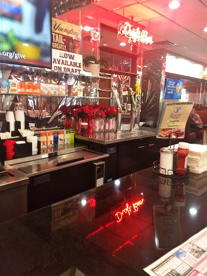 Even the bar area maintains that classic diner aesthetic. Those red roses add a touch of "we care" to the chrome and neon landscape.