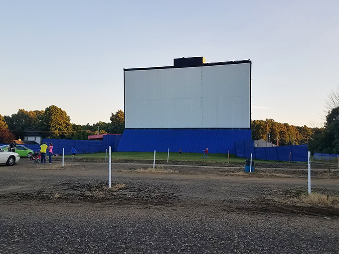 The screen stands ready at dusk, like a patient storyteller waiting for darkness to fully descend before sharing its tales.