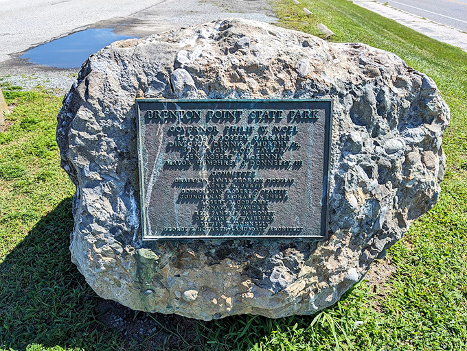 History set in stone. The dedication plaque reminds us that even paradise has a backstory worth preserving for future generations.