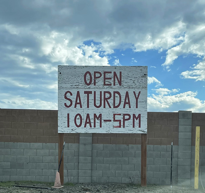 The most honest business sign in America. No fancy marketing, just the straight facts about when to show up for treasure hunting.