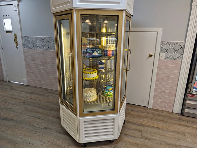 The rotating cake display&mdash;a carousel of celebration where every revolution brings another reason to say "yes" to dessert.