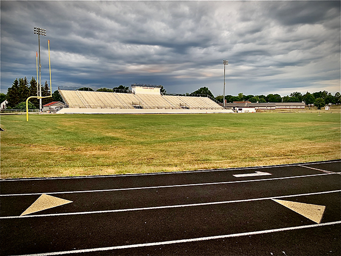 Cameron Stadium awaits under brooding clouds, where generations of Bangor athletes have chased dreams across its storied field.