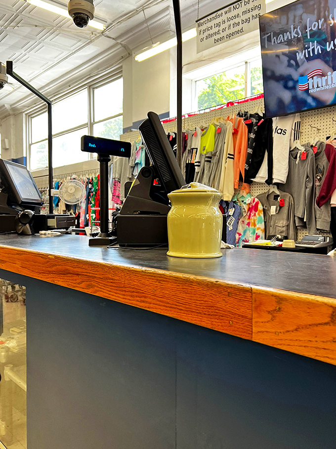 The checkout counter, where thrifting victories are tallied and that yellow ceramic jar has witnessed thousands of "You won't believe what I found for just $3!" stories.