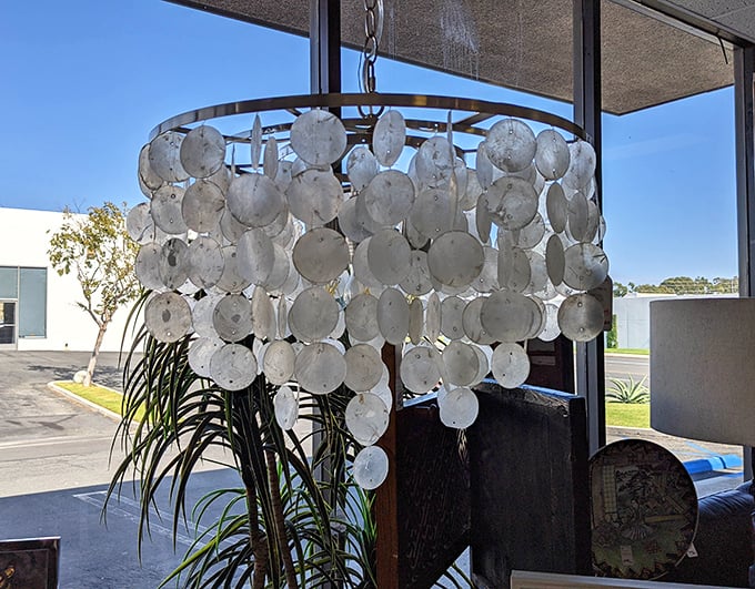A capiz shell chandelier catches sunlight from nearby windows. Imagine this statement piece transforming your dining room for less than the cost of a fancy dinner out.