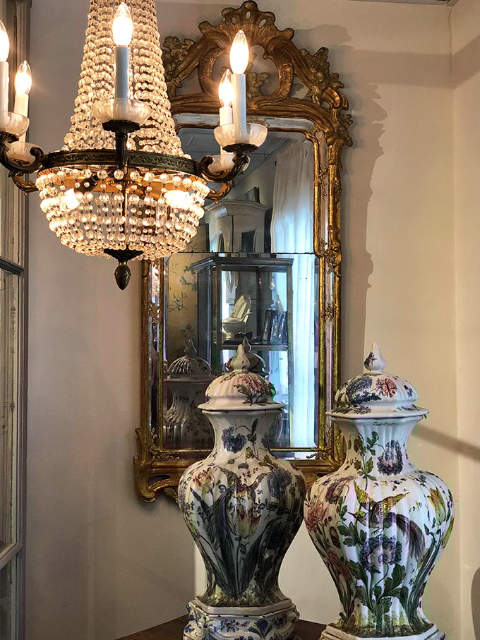 A chandelier that's seen more dinner parties than you've had hot meals, alongside porcelain that survived centuries of careful handling.