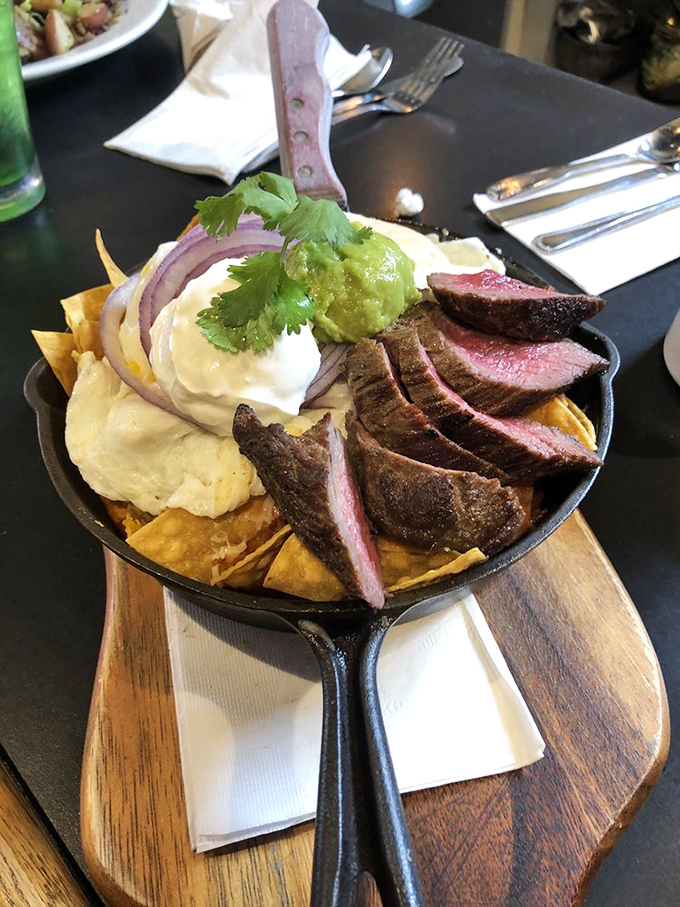Steak nachos reimagined for brunch&mdash;perfectly medium-rare slices atop crispy tortilla chips with all the fixings in a cast iron delivery system.
