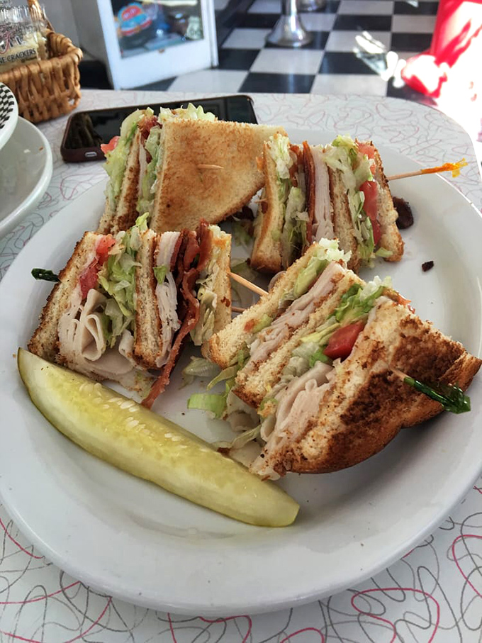 The club sandwich stands tall and proud, layers stacked with military precision but tasting like your grandmother made it&mdash;if grandma was secretly a gourmet chef.
