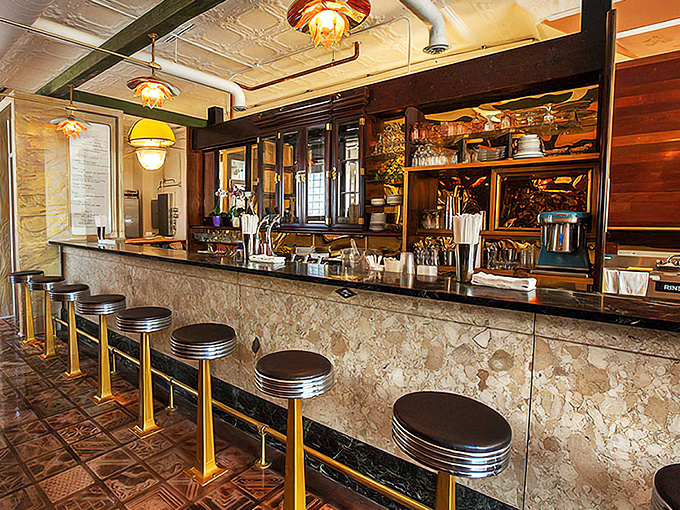 The marble counter and vintage stools aren't retro by design&mdash;they're authentic survivors from an era when craftsmanship wasn't optional.