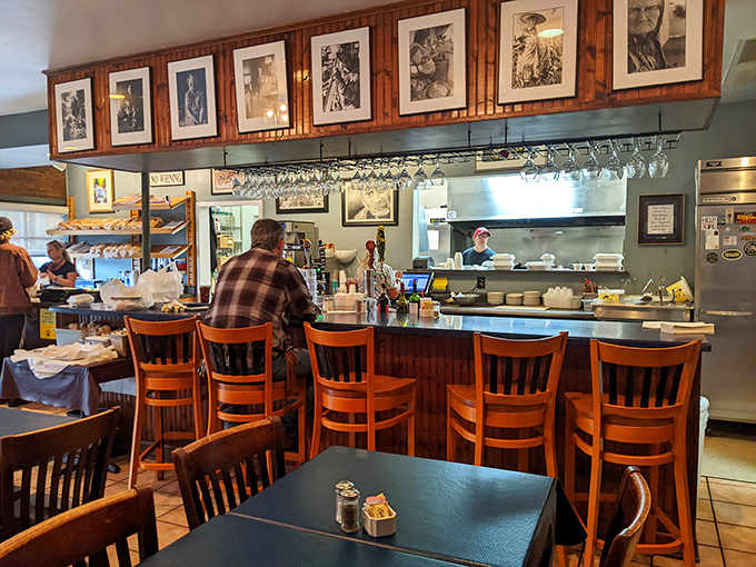 The counter seating offers front-row tickets to culinary theater. Those framed photos above aren't just decoration &ndash; they're silent witnesses to countless satisfied sighs.