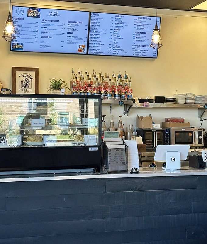 The breakfast menu board looms above, promising morning delights that make hitting the snooze button seem like a crime.