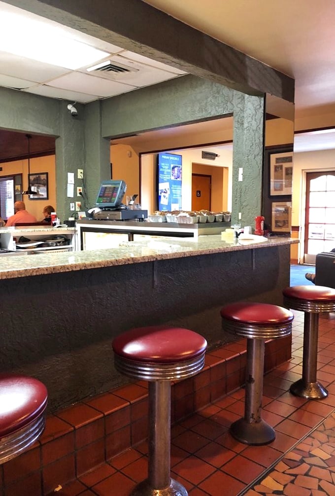 Classic diner counter seating – where solo diners become philosophers and coffee cups never stay empty for long.
