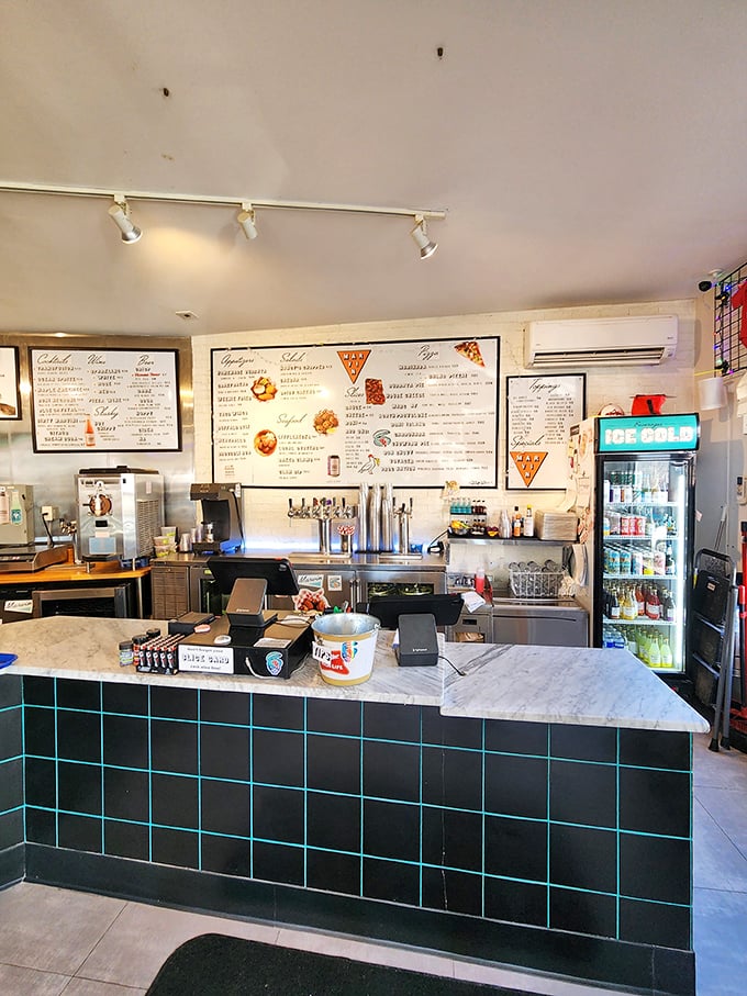 Behind the black-tiled counter with its marble top, pizza magic happens in full view&mdash;no secrets, just craftsmanship you can watch unfold.