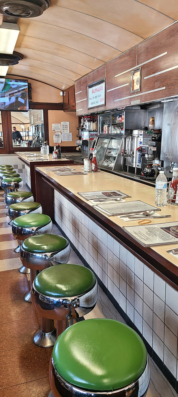 The counter beckons with its gleaming chrome and green vinyl stools, a front-row seat to the breakfast ballet performed by seasoned short-order cooks.
