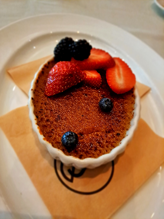 Cr&egrave;me br&ucirc;l&eacute;e topped with fresh berries&mdash;the perfect ending that won't leave you needing a forklift to leave the restaurant.