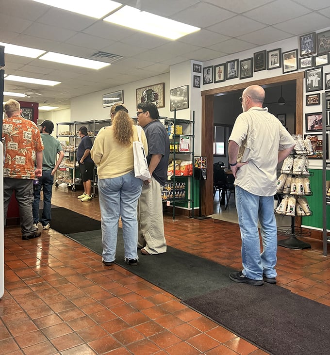 The universal language of waiting. Customers patiently line up, united by the shared understanding that some things—like Orsi's pizza—are absolutely worth the wait.