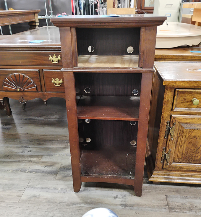 This wooden shelving unit has probably held everything from encyclopedias to someone's prized snow globe collection.