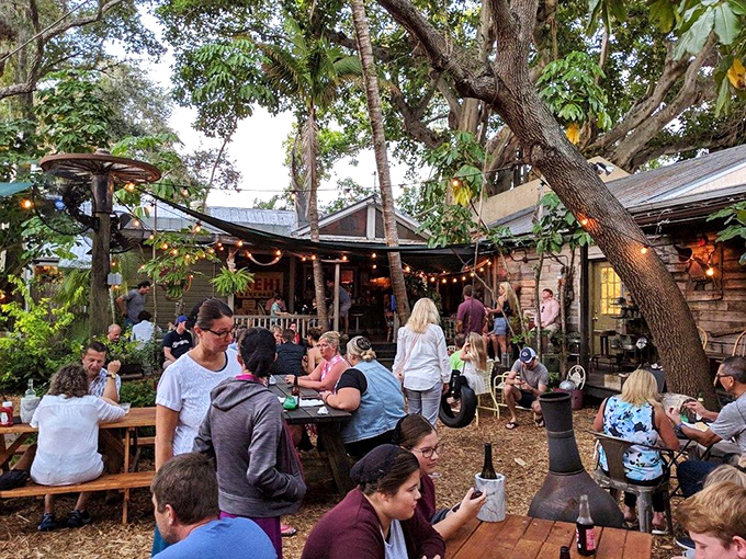 The backyard dining area buzzes with the energy of a neighborhood block party, where strangers become friends over shared plates and fishing stories.