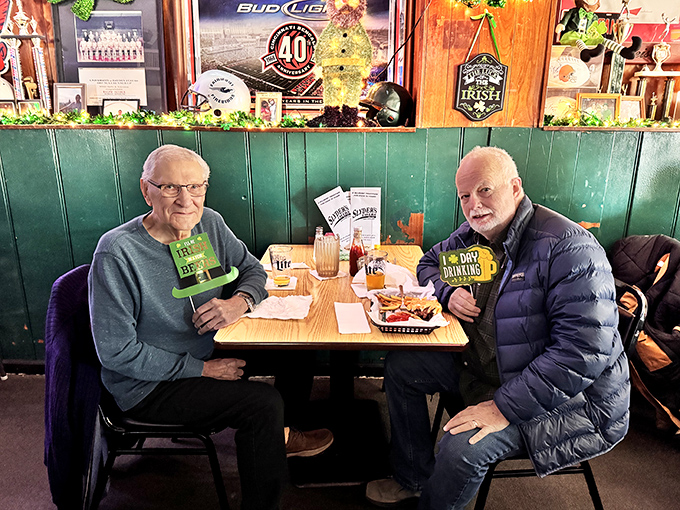 Regulars celebrating with festive props—because when you've found your burger home, every visit is worth celebrating. Loyalty tastes delicious.