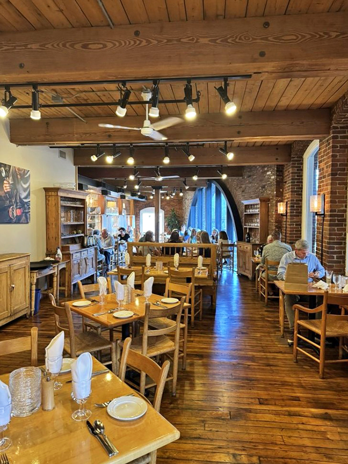 The dining room hums with conversation and contentment, wooden beams overhead witnessing countless perfect meals.
