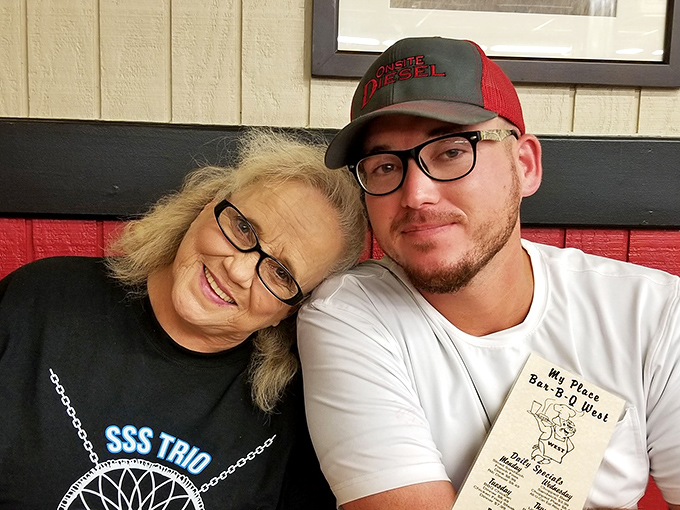 The warm, family-style atmosphere at this local BBQ institution is as much a part of the experience as the hickory-smoked delights on your plate.