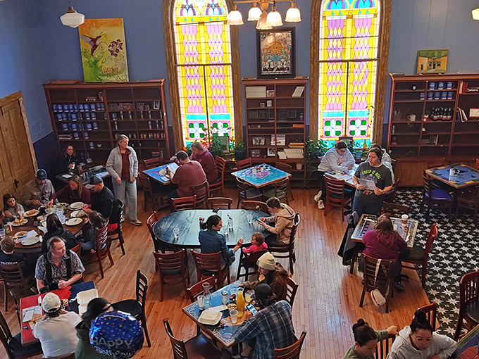 
From above, the dining room reveals its former life as a sanctuary, now filled with a different kind of communion &ndash; one involving pancakes and conversation. 