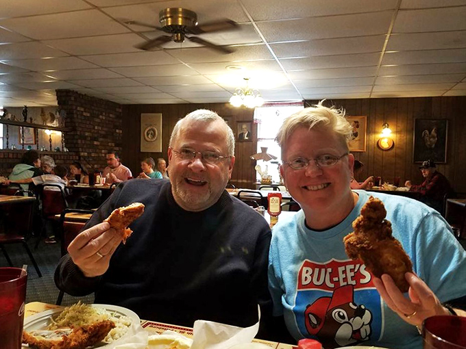 The universal language of great food: two happy diners proudly displaying their chicken like they've struck culinary gold.