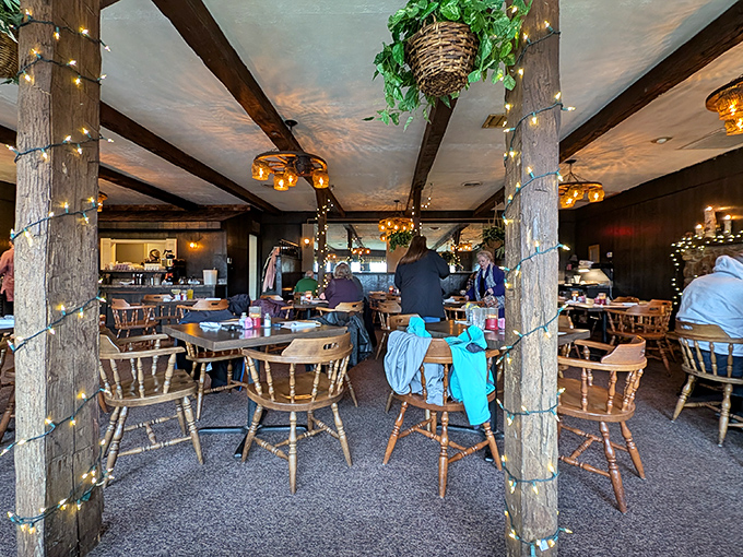The dining room buzzes with the energy of happy eaters, each wooden post wrapped in twinkling lights like it's always a special occasion.