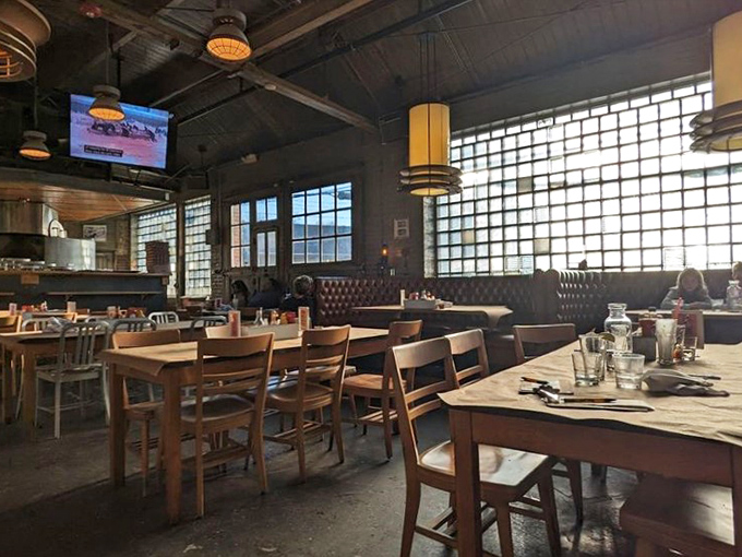 High ceilings and vintage signage create a dining room where every seat feels like the right choice.