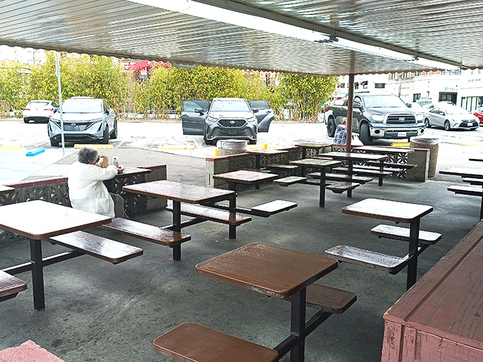 Simple picnic tables under metal awnings&mdash;because great food doesn't need fancy furniture to taste absolutely incredible.