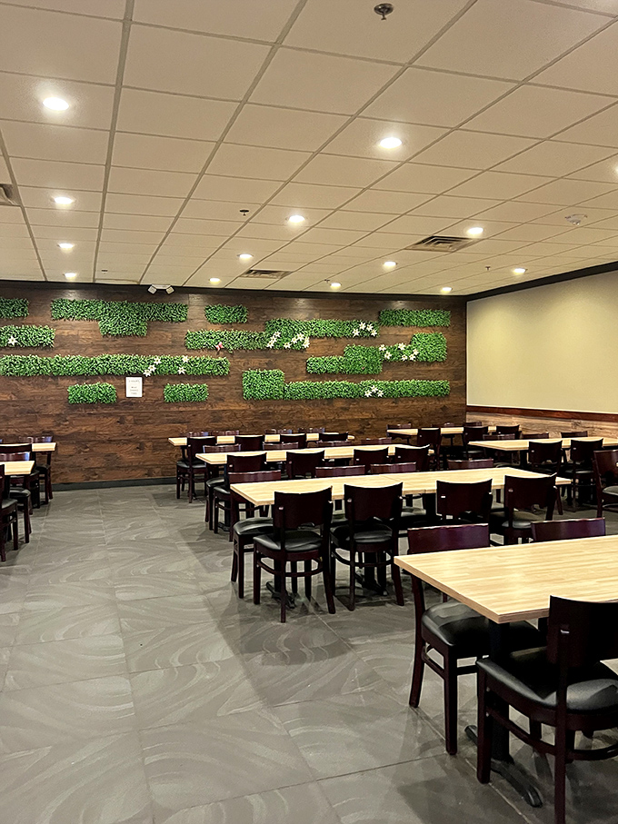 Modern meets cozy in this dining area, where the living wall of greenery silently judges your fourth trip to the dessert station.