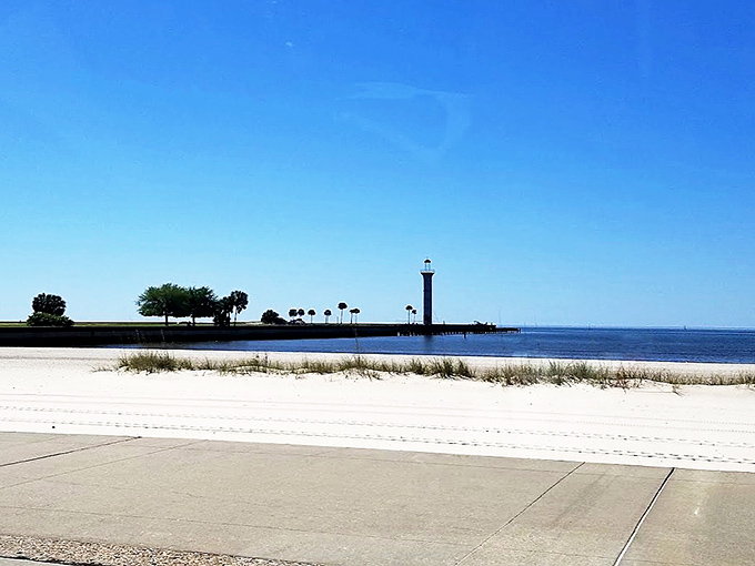 Sometimes the best beach views come with a side of white sand and a lighthouse keeping eternal watch.