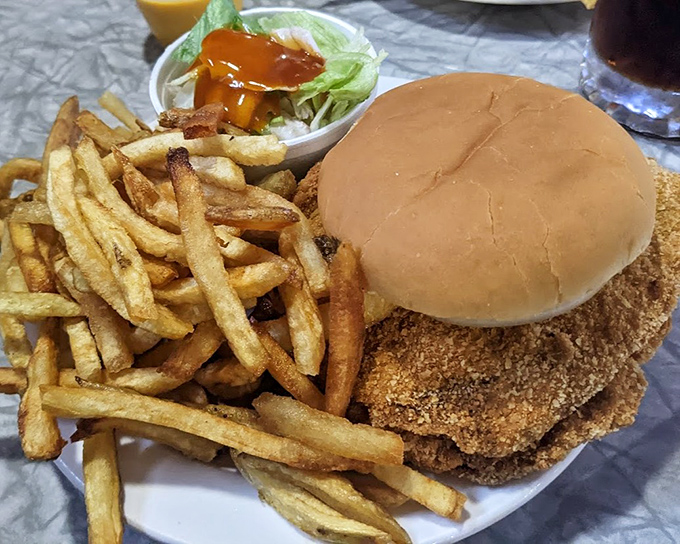 The double pork tenderloin sandwich with fries &ndash; a plate that says "you won't need dinner" with absolute confidence.