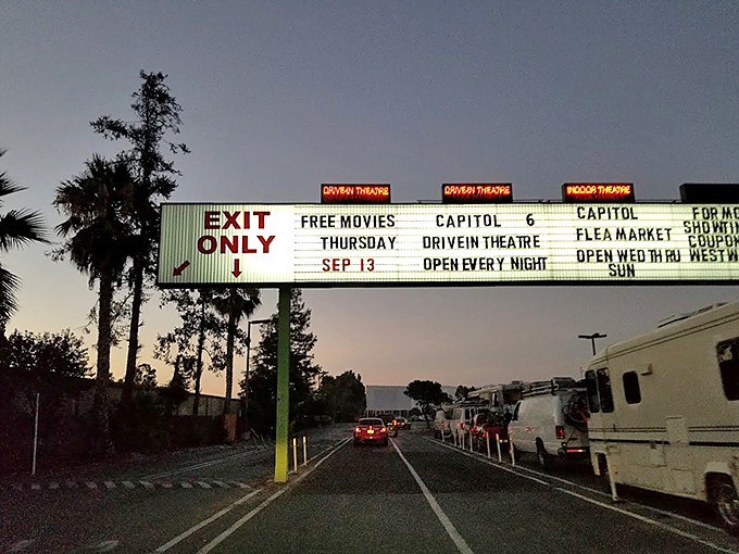 The exit marquee serves as both information center and time machine, its vintage lettering announcing "FREE MOVIES THURSDAY" like a beacon of bygone Americana.