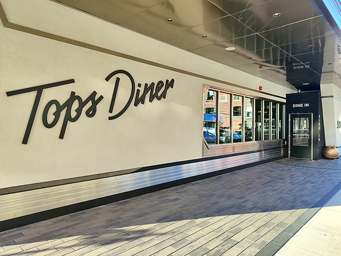 The waiting area offers a moment of anticipation, with warm wood tones and a playful diner artwork hinting at the experience to come.