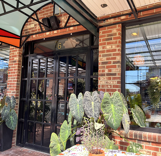 The entrance beckons with lush greenery and architectural details that whisper, "Yes, this place takes breakfast seriously."