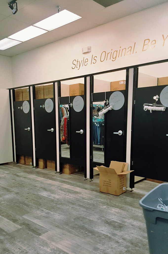 "Style Is Original. Be You." The fitting room area offers privacy and inspiration in equal measure for fashion-forward decision making.
