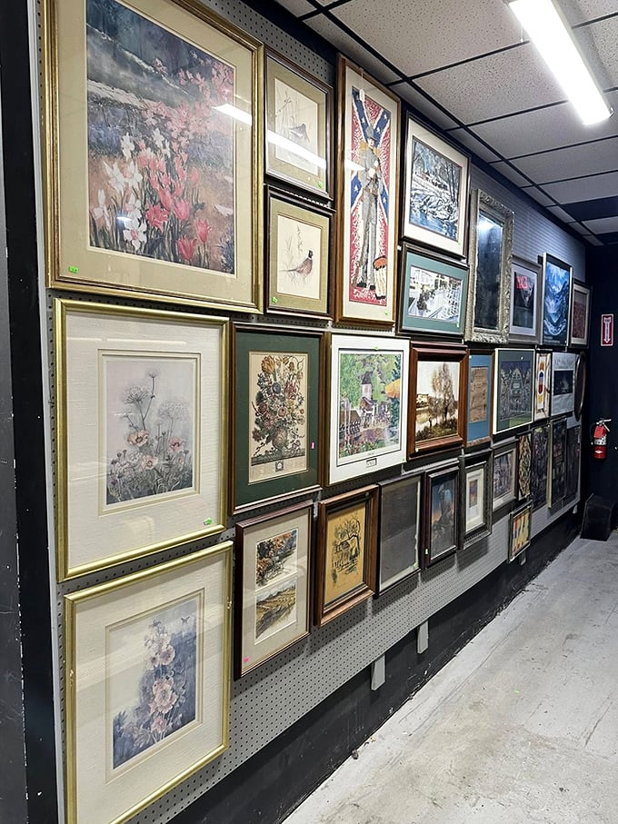 The wall of framed art offers instant sophistication for bare walls. From landscapes to abstracts, your perfect conversation piece waits among this gallery of second chances.