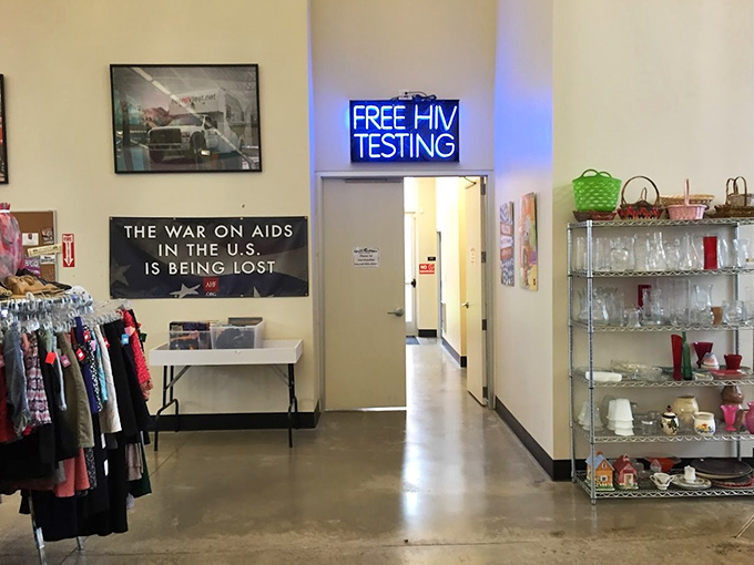 Beyond bargains, this corner offers potentially life-saving services. The neon "Free HIV Testing" sign represents the store's deeper mission of community health support.