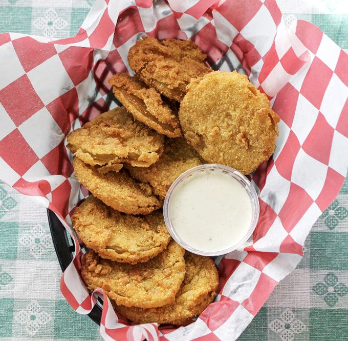 Fried green tomatoes with ranch&mdash;a Southern delicacy that makes you wonder why anyone bothers waiting for tomatoes to ripen. Tangy perfection in every bite.