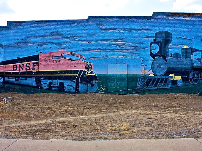 This vibrant train mural transforms a plain brick wall into a colorful history lesson about Glasgow's railroad roots.